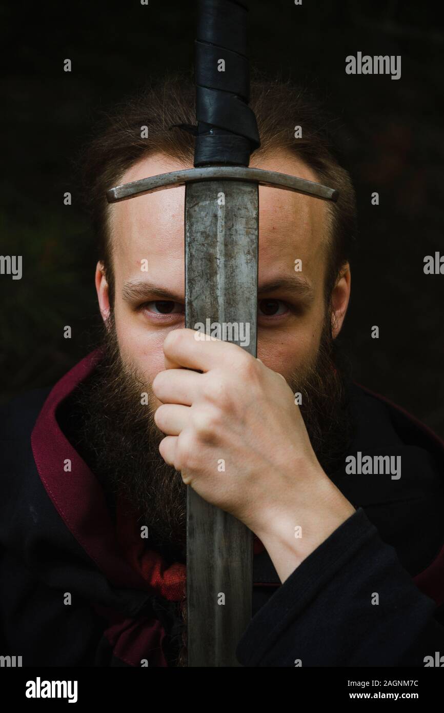portrait of a knight holding a sword in the face Stock Photo - Alamy