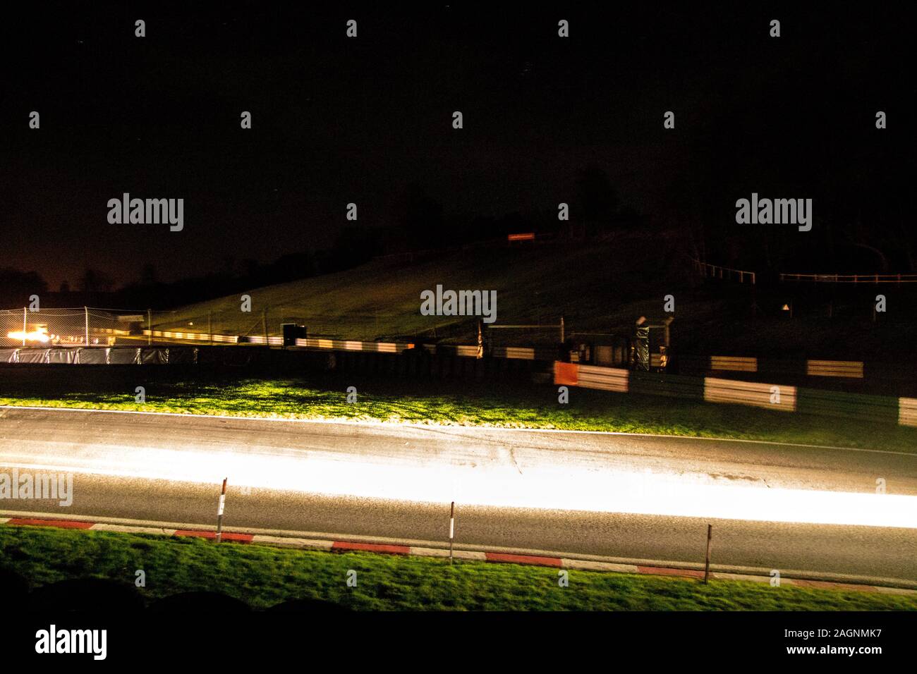 A rally undertaken on a racetrack, carried out at night / dusk Stock ...