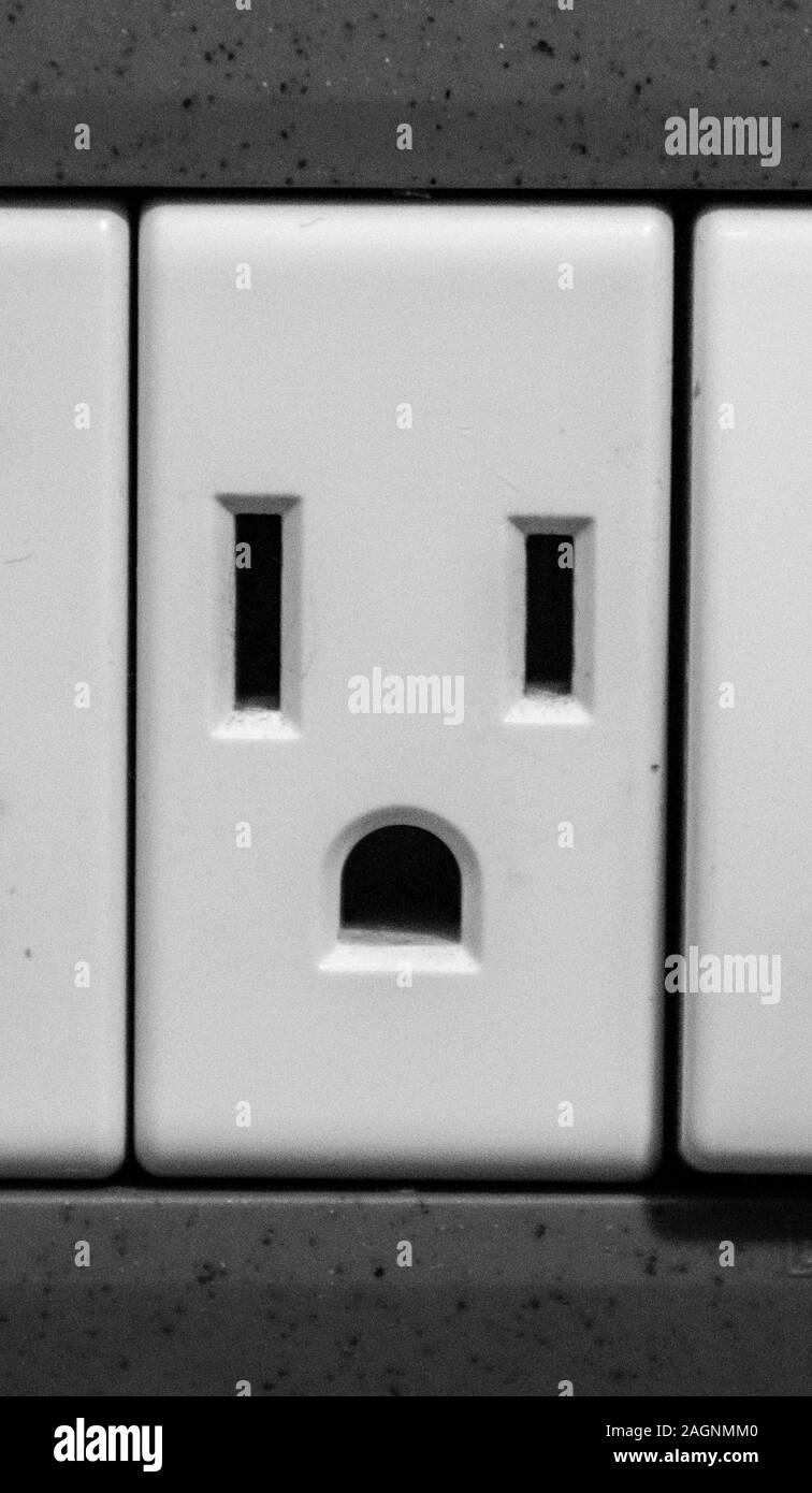 A typical American plug socket which looks like a frightened face Stock ...