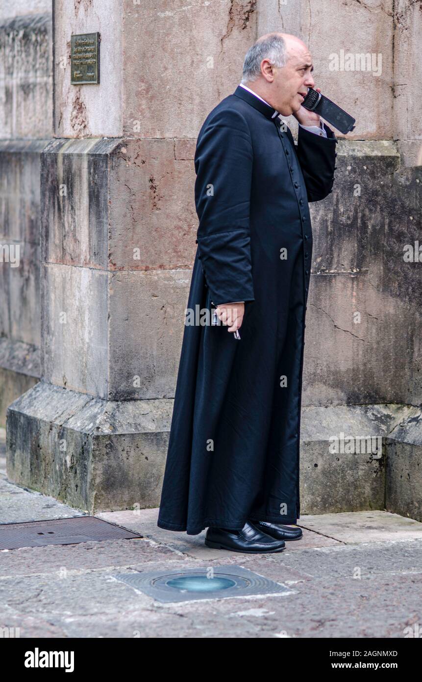 Priest on phone hi-res stock photography and images - Alamy
