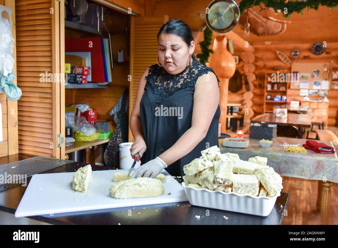 Indigenous woman cutting bannock bread , Northern Quebec Stock Photo ...