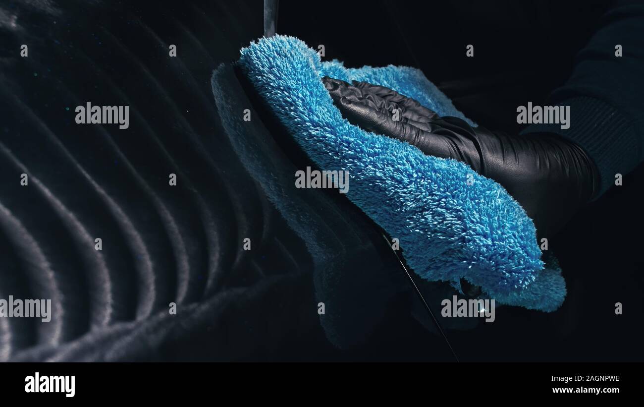 Using rag in palm of your hand, finish liquid car polish are removed ...