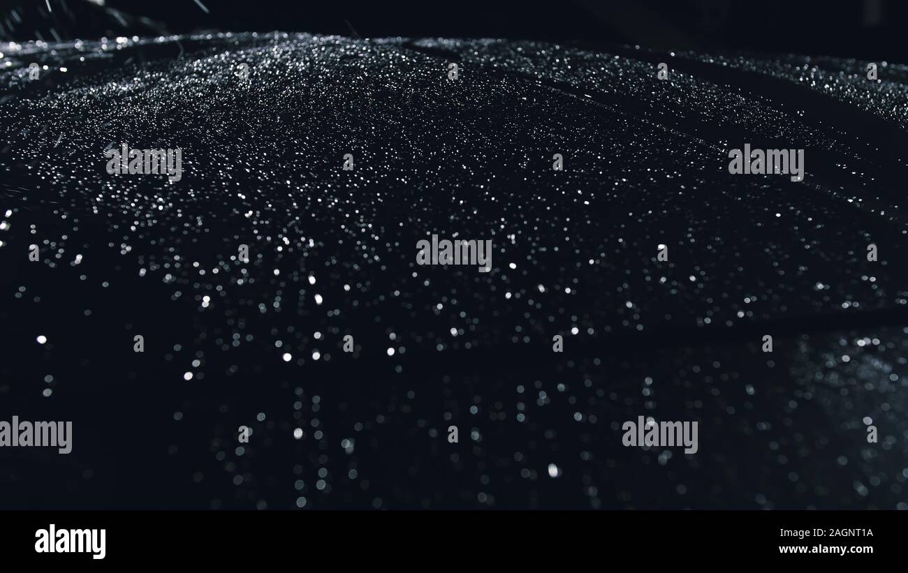 Drop flow down the hood. Close up view of bonnet car. Dark black ...