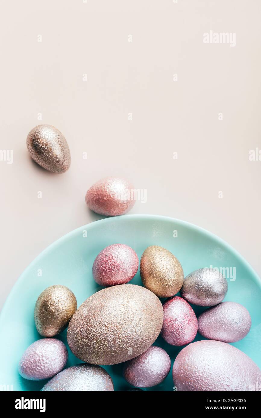 Colored chicken and quail eggs of pink, silver, golden and blue color ...