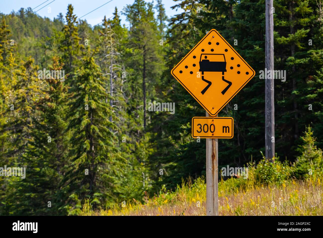 A close up view of a hazardous road condition sign in Canada, pavement ...
