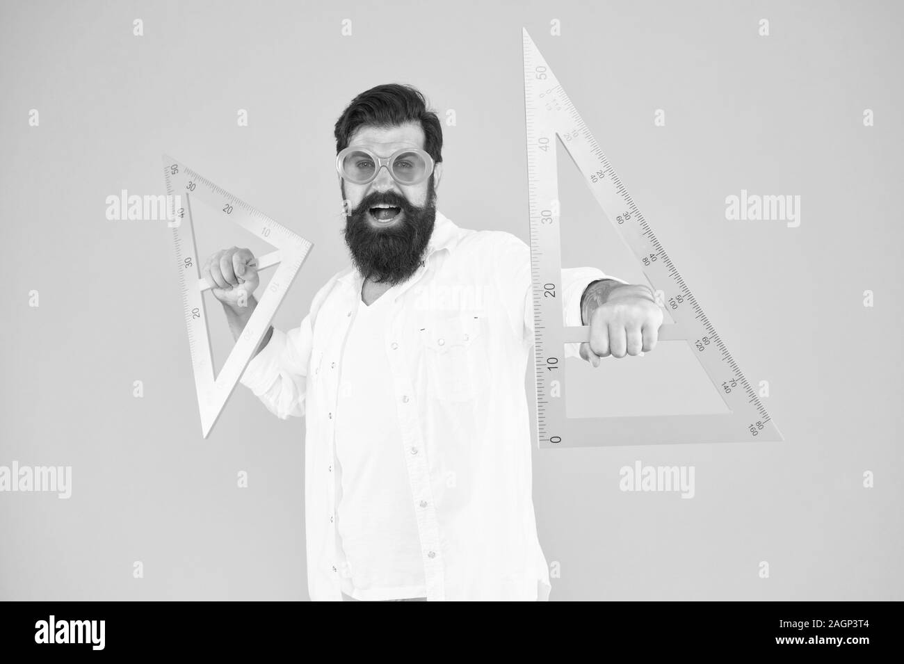 Making geometry fun. Funny hipster using geometrical tools at geometry ...