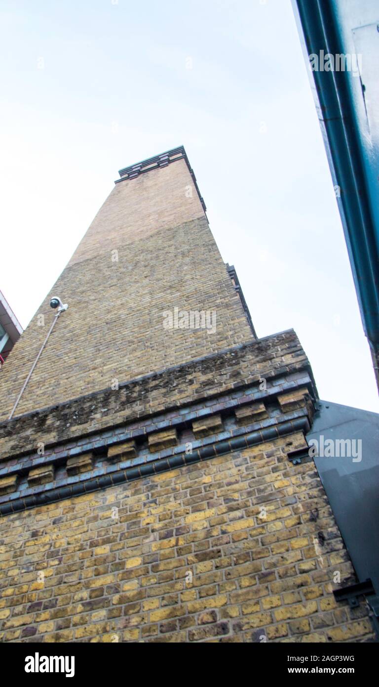 A very tall brick tower in the city center of London, United Kingdom ...