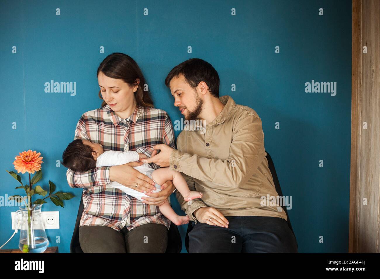 Happy young parents and baby together at home. Family, childhood and ...