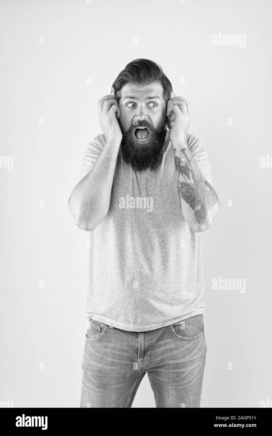 High voltage music. Hipster listen to music. Bearded man wear ...