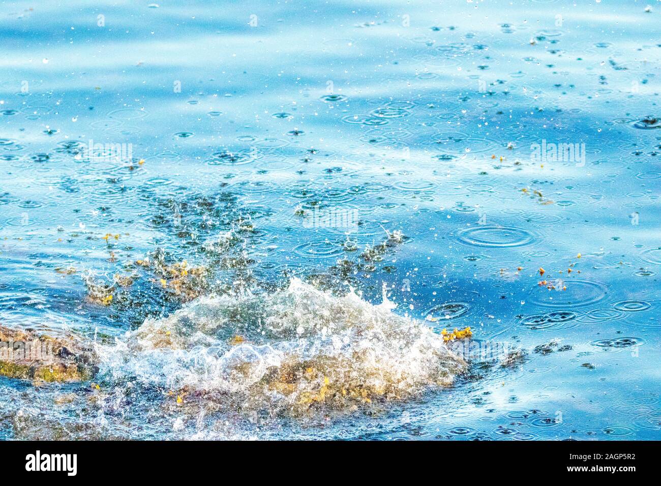 Splashes in the sea front waters Stock Photo - Alamy