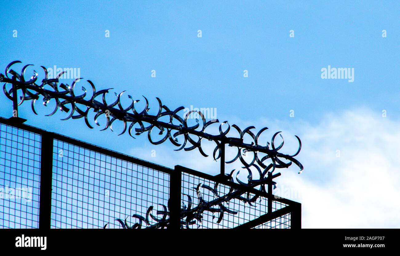 A very sharp fence line at the top of a wall to protect individuals ...