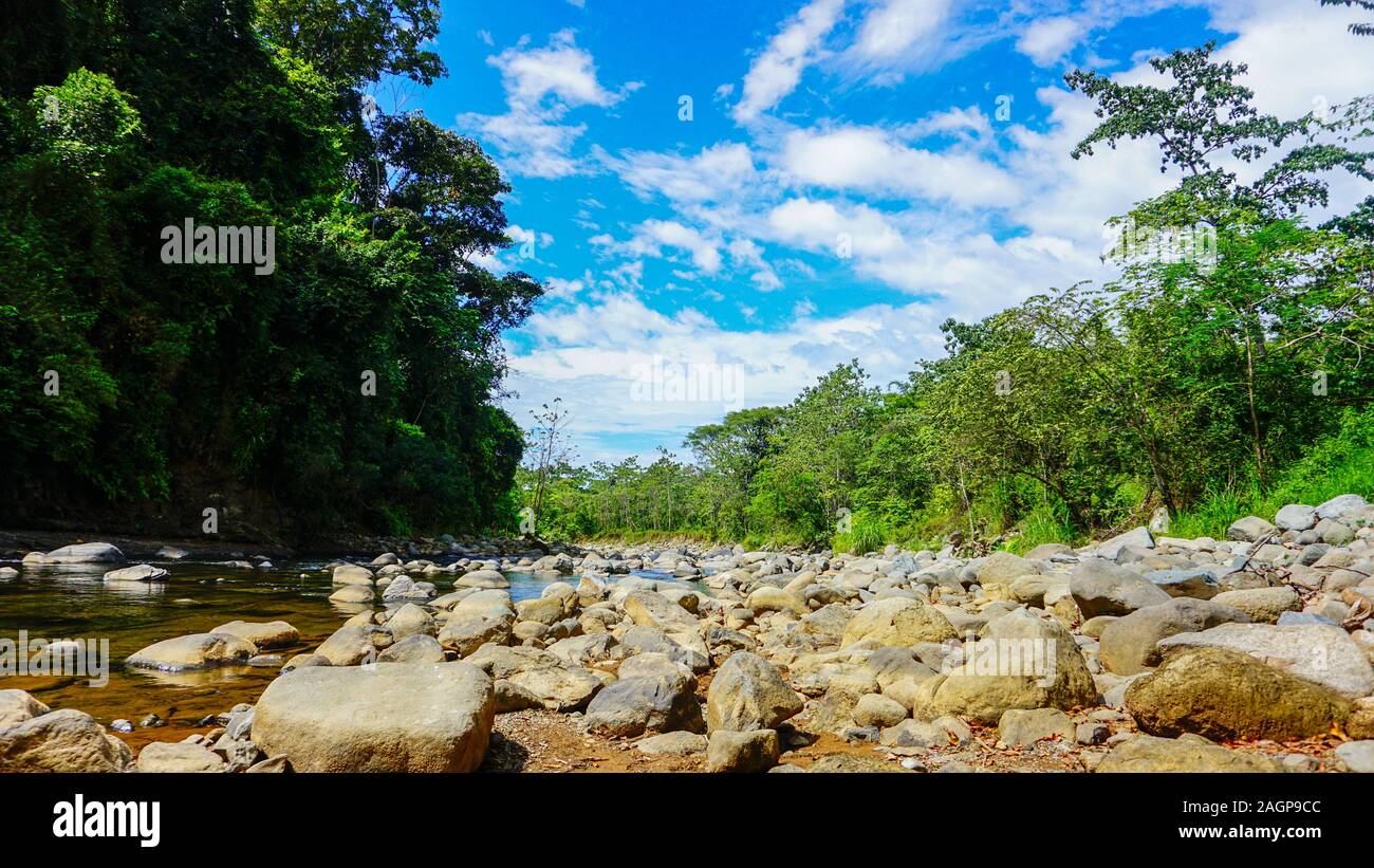 Landscape photo of a small river floating down between the big rocks ...