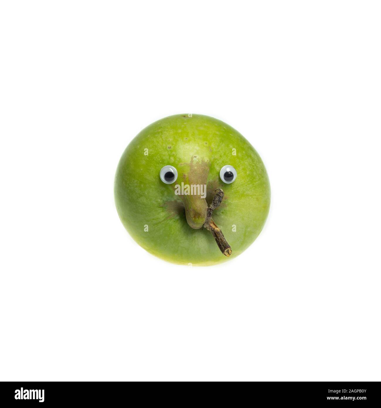 Trendy ugly food concept. Green funny apple with eyes isolated on white ...