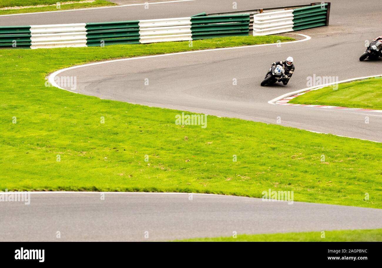 Motorbikes race around the famous track at Cadwell Park, in England, UK ...