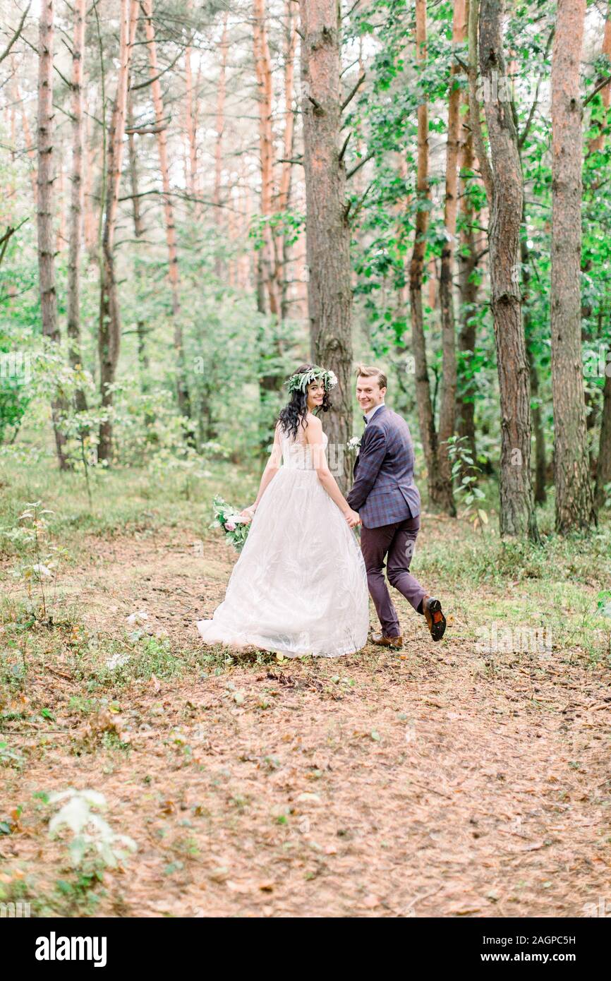 Back view of stylish rustic couple of newlyweds on their wedding day ...