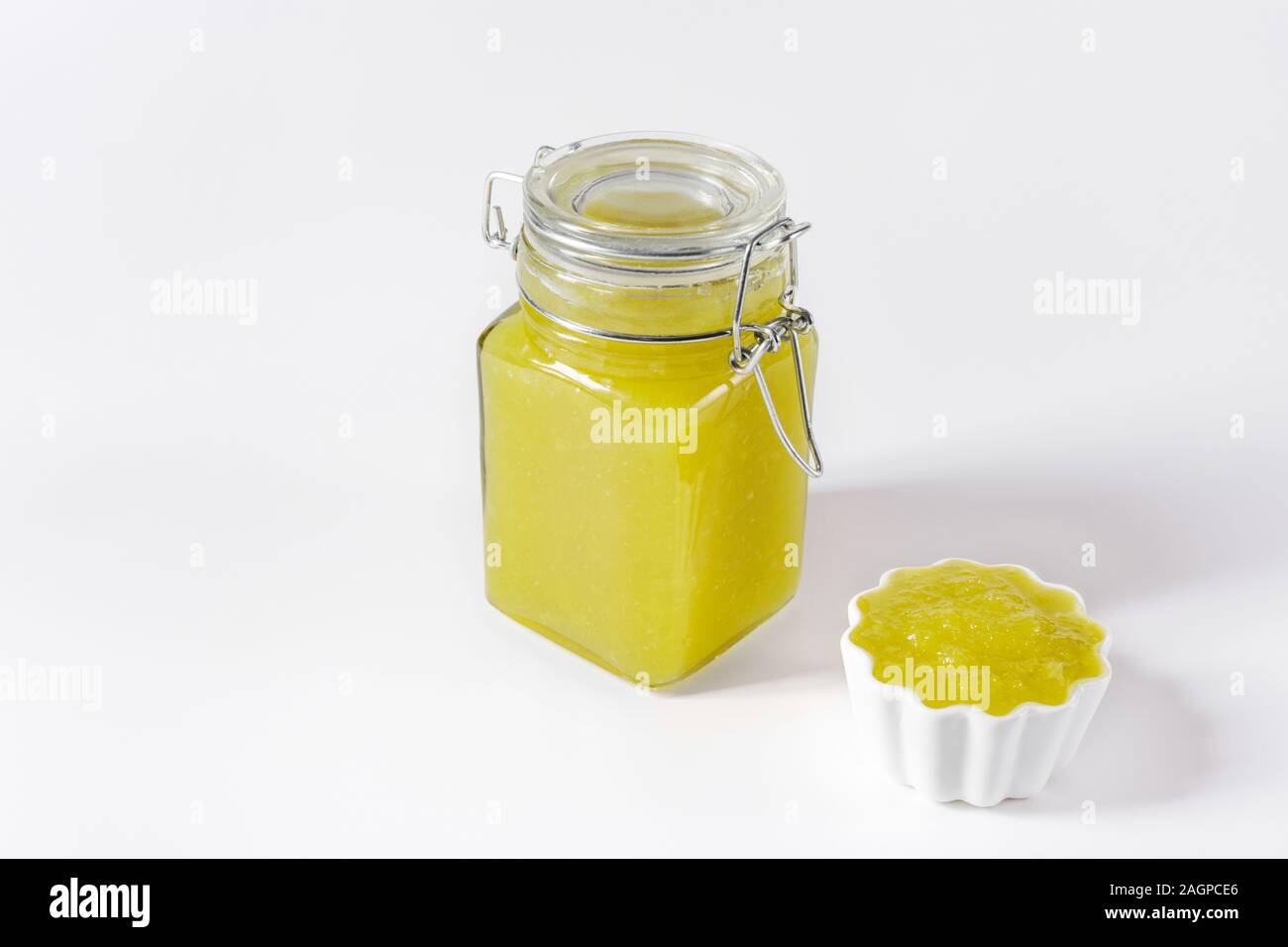 Homemade delicious green jam in glass jar and bowl on white background ...