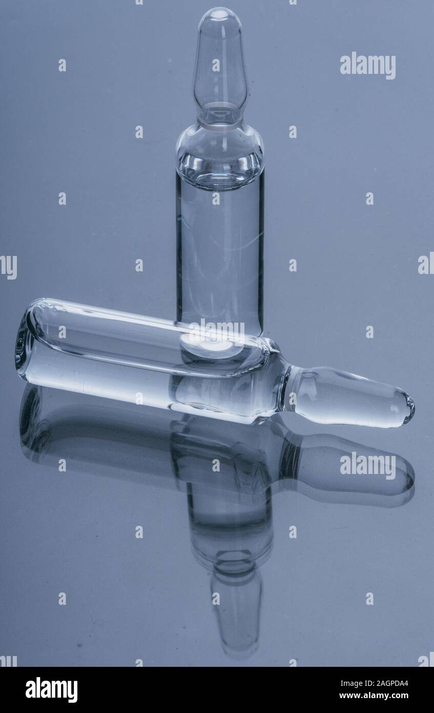 Glass medical ampoule vial for injection. Medicine is dry white drug ...