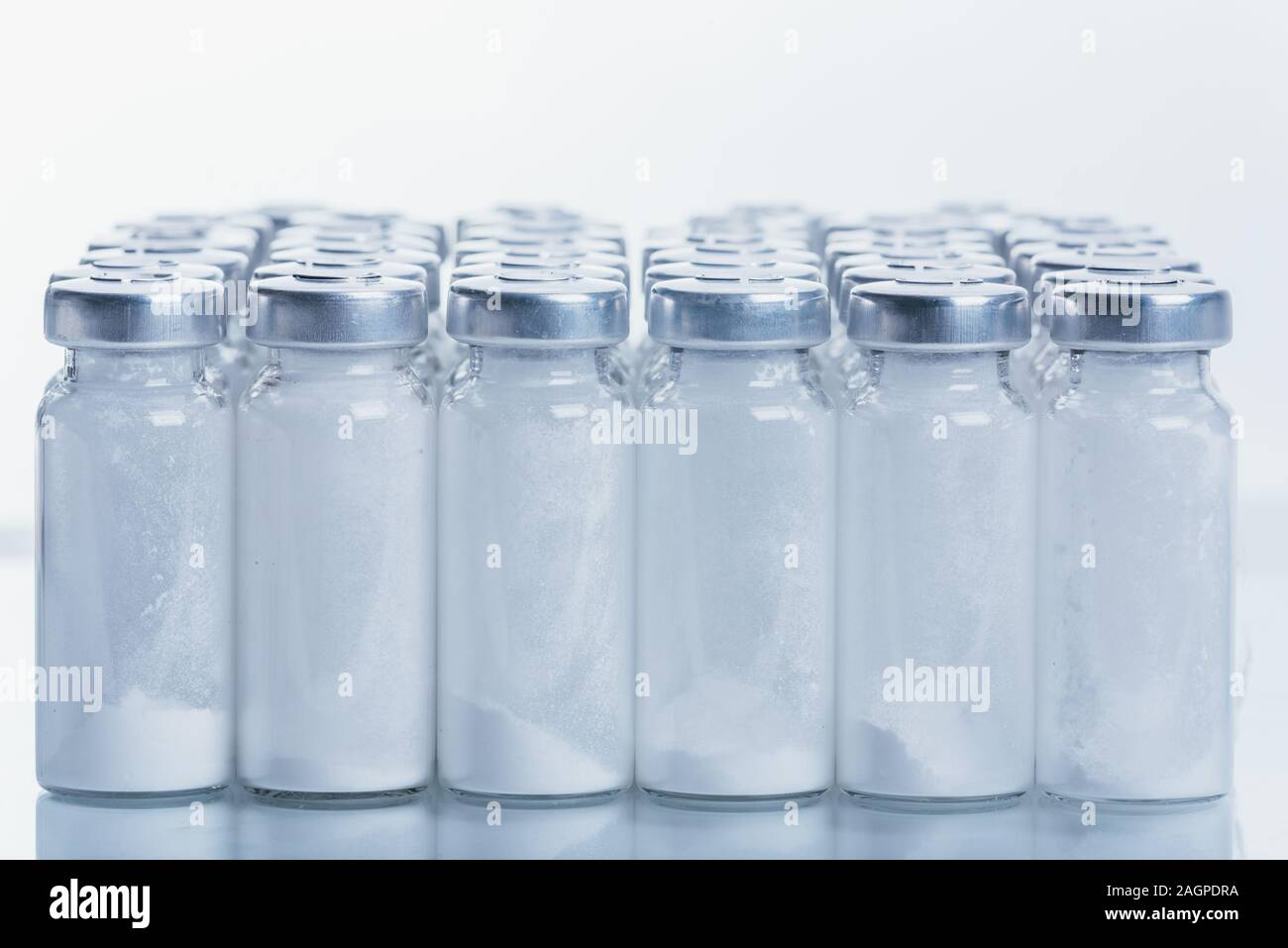 Glass medical ampoule vial for injection. Medicine is dry white drug ...