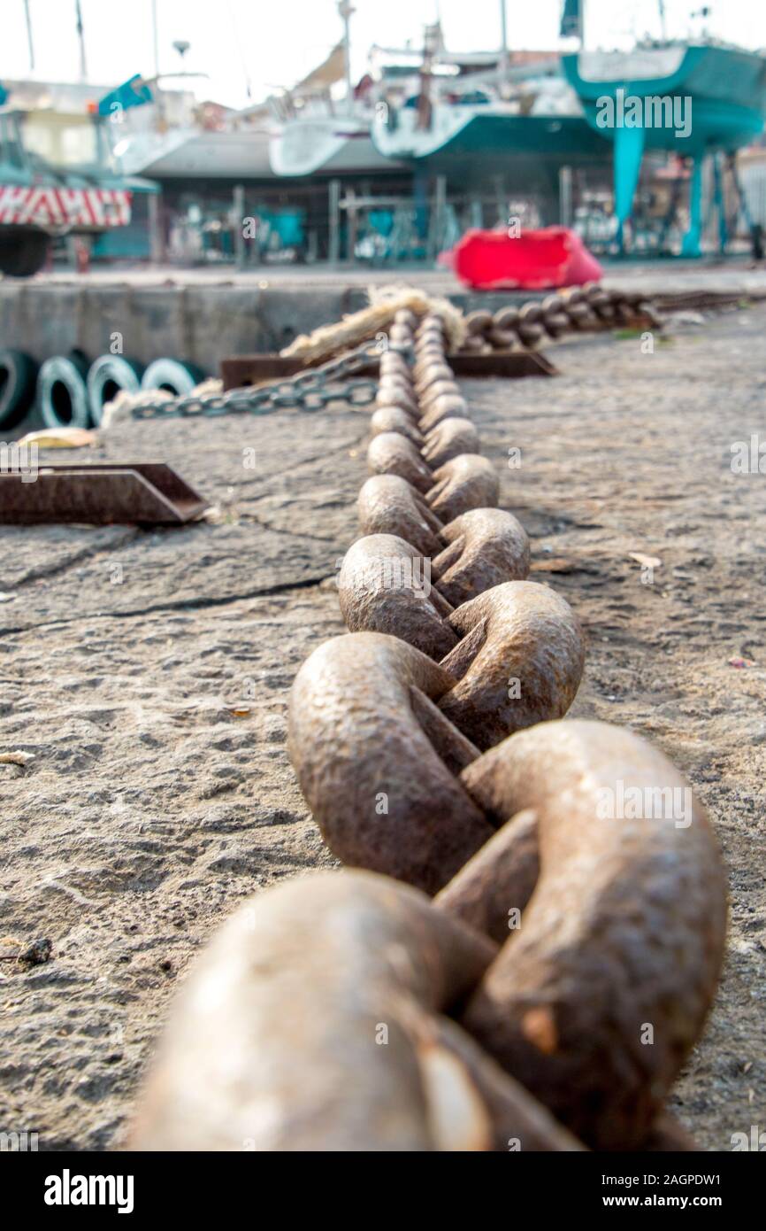 A view from the ground looking alone harbor wall chains Stock Photo - Alamy