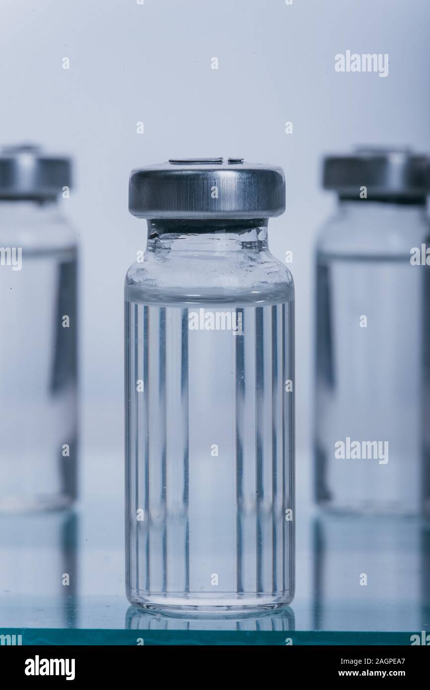 Glass medical ampoule vial for injection. Medicine is dry white drug ...