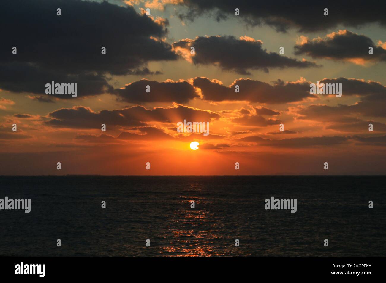 Beautiful blazing sunset landscape over the horizontal line on the sea ...