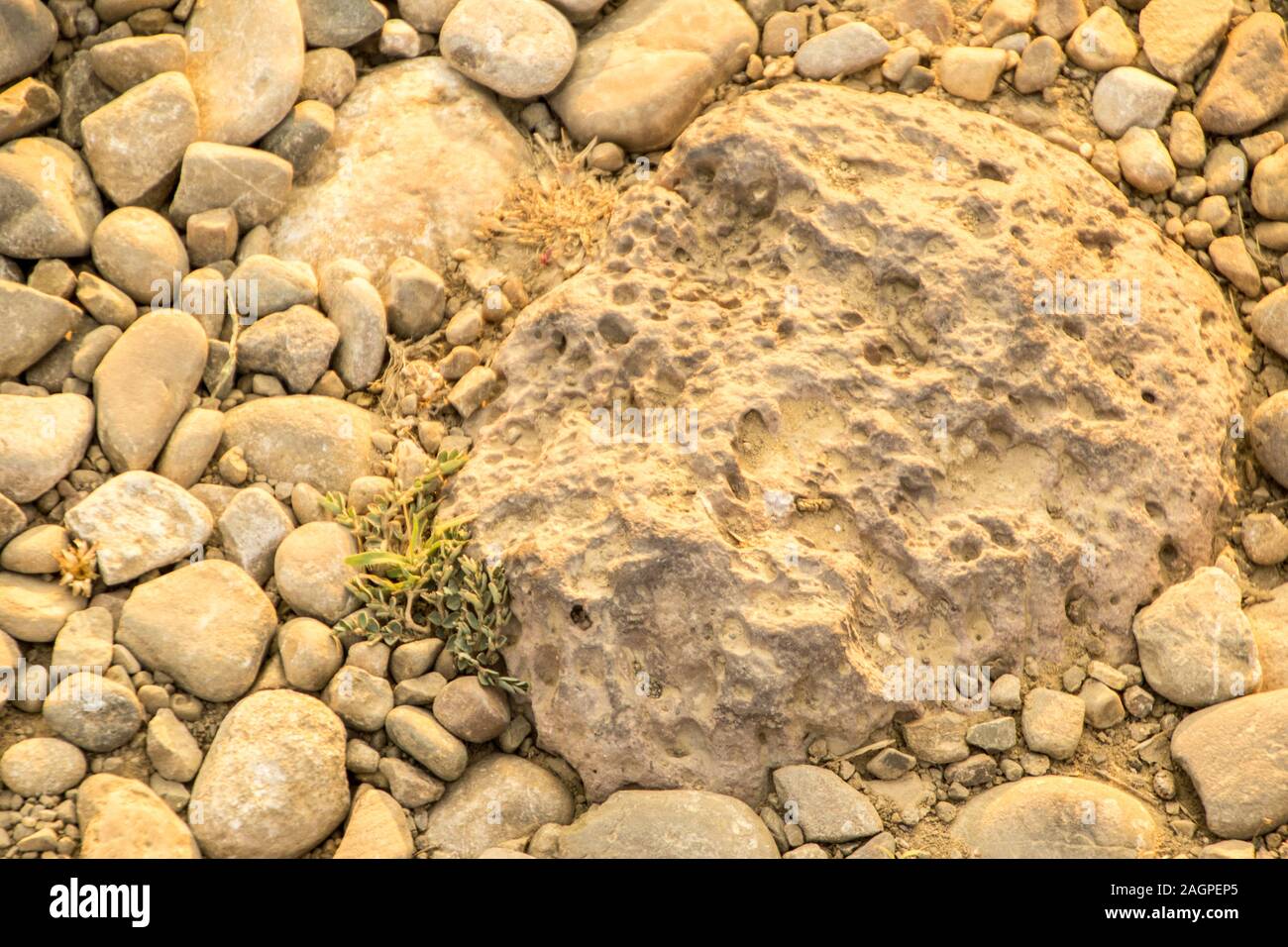 A collection of random sized stones on the ground, which will make a ...