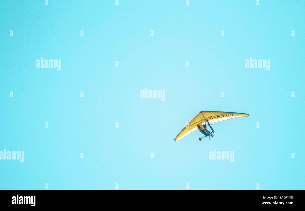 A small aircraft, a microlight, flies overhead enjoying the clear skies ...