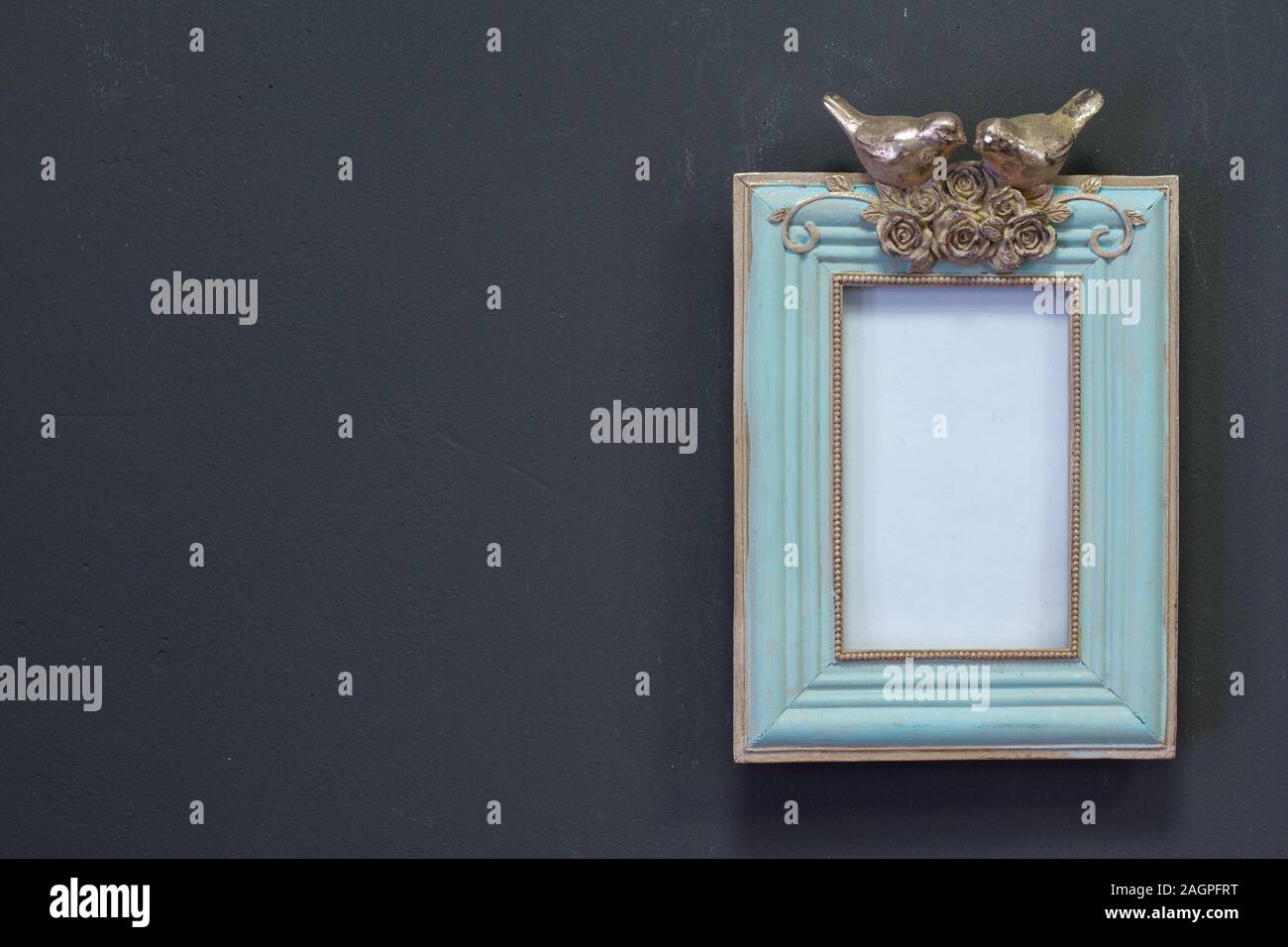 Empty mint golden vintage square frame in Victorian style on a gray ...