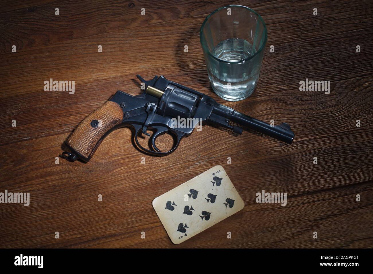 russian roulette - Eight of Spades plaing card, glass of vodka and ...