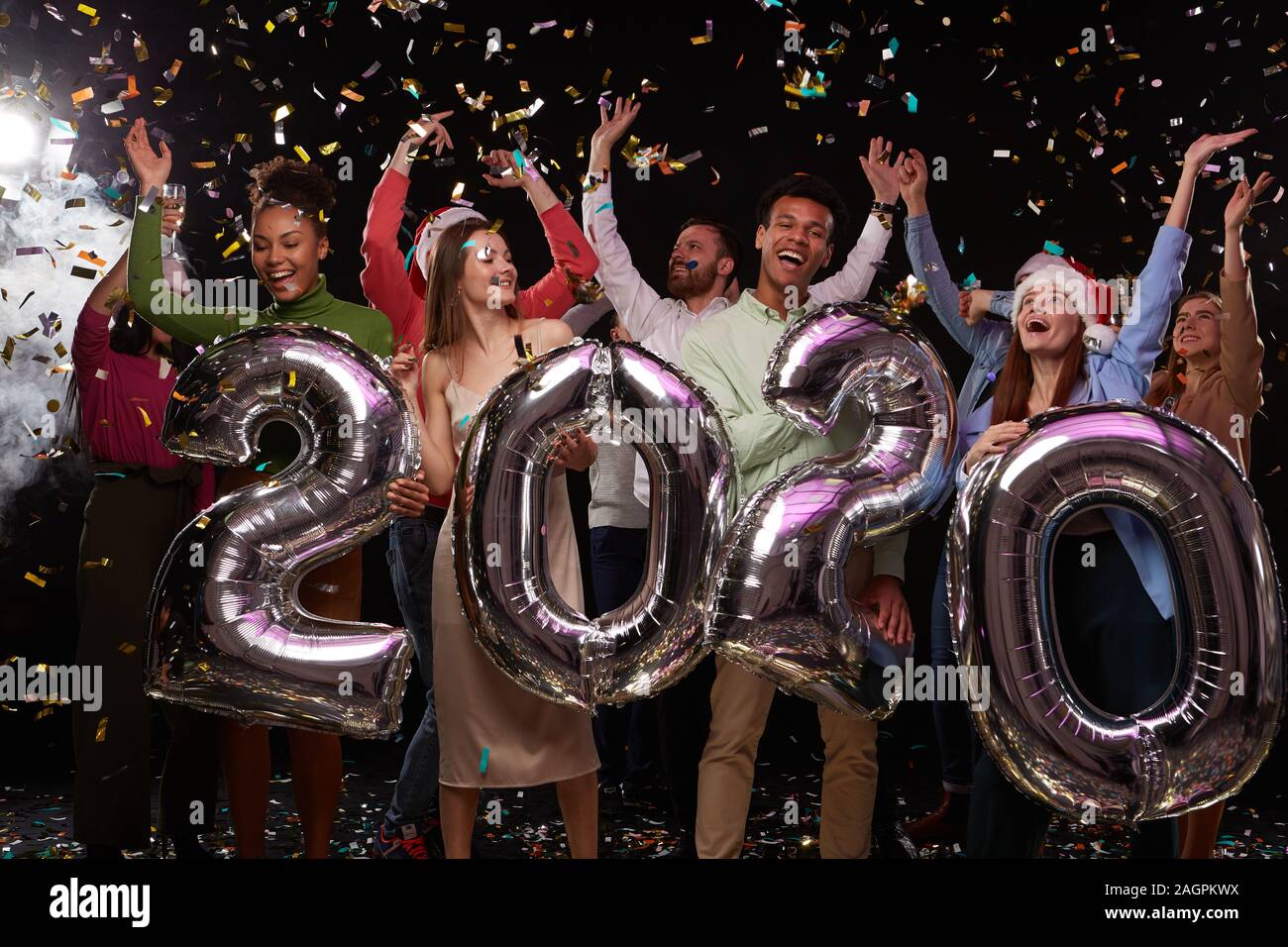 New 2020 year is coming. Group of happy multiethnic people holding ...