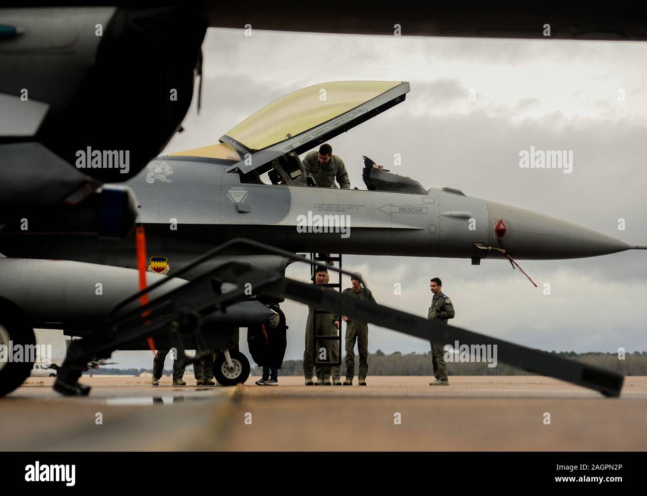 An Airman examines the interior of an F-16 Fighting Falcon Dec. 10 ...
