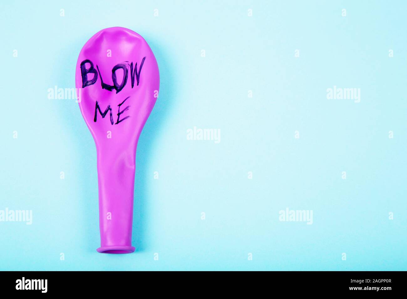 Pink rubber unblown balloons on a light blue background. With note blow ...