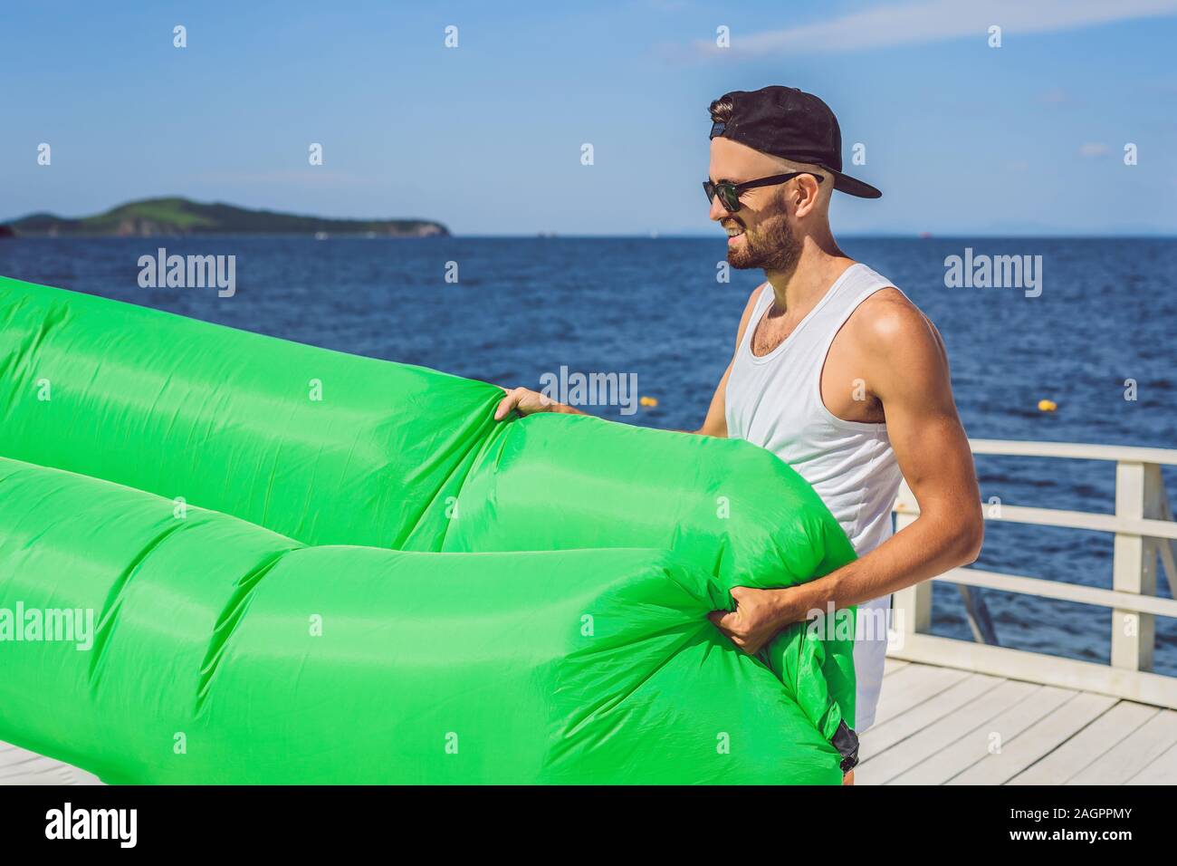 Man tries to inflate an air sofa. lamzac Stock Photo - Alamy