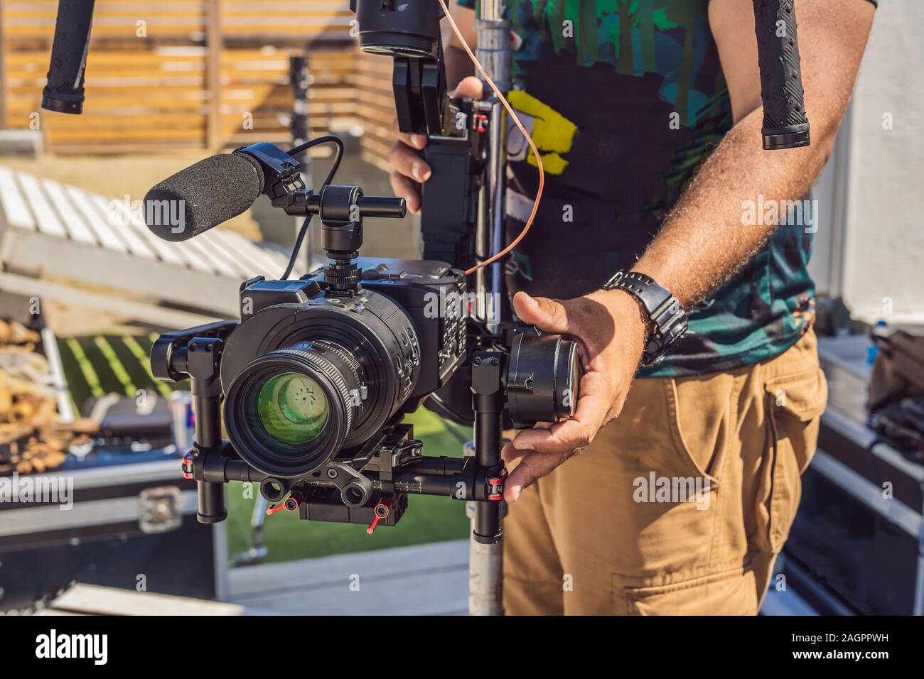 Steadicam operator prepare camera and 3-axis stabilizer-gimbal for a ...