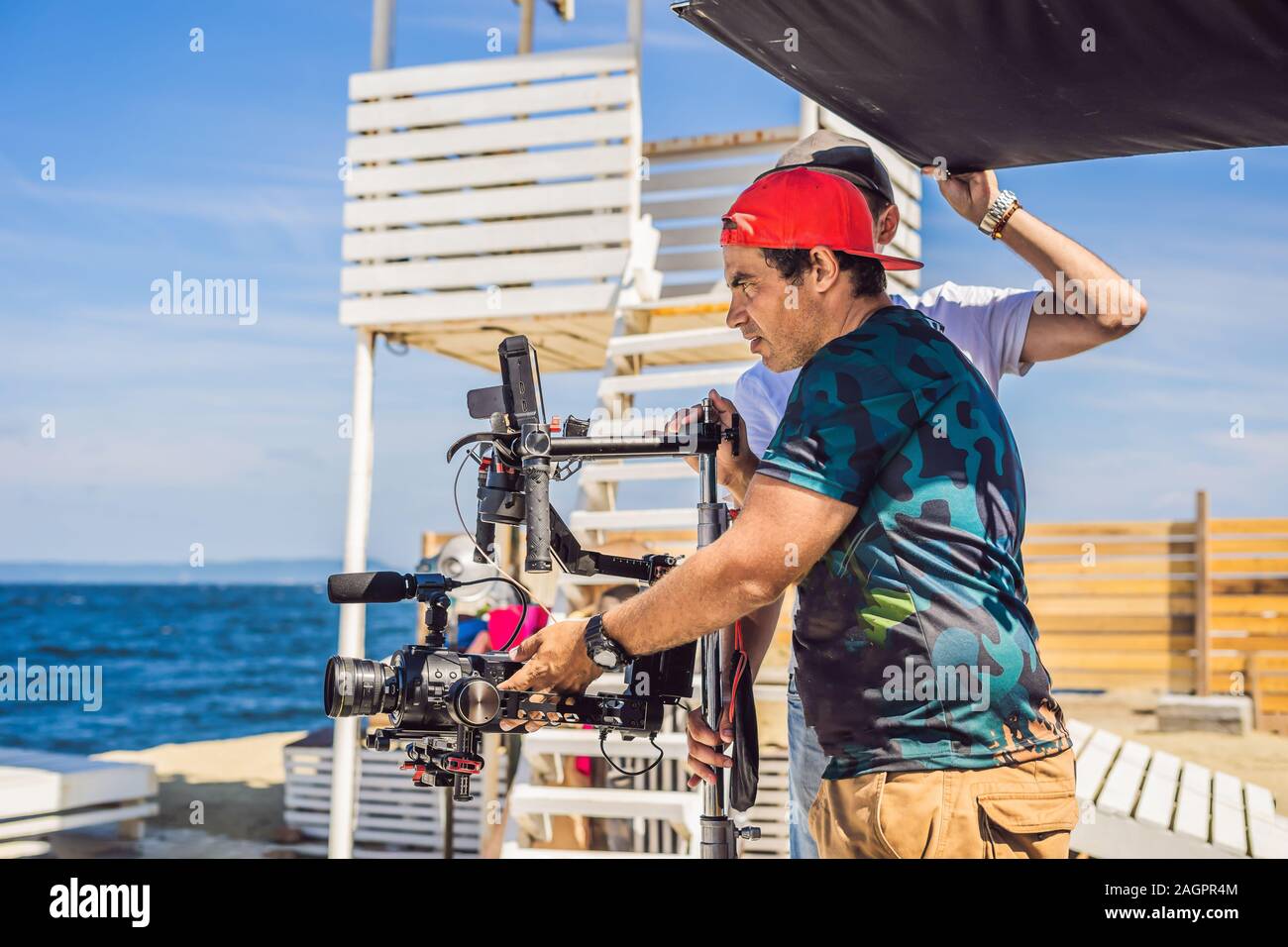 Steadicam operator prepare camera and 3-axis stabilizer-gimbal for a ...