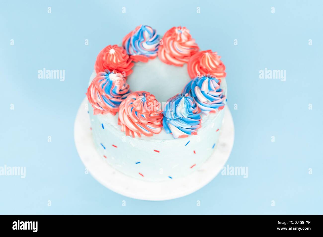 Red, white, and blue round cake frosted with buttercream frosting Stock ...