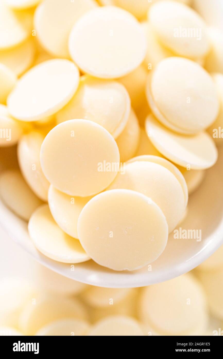 White round chocolate chips for melting chocolate shapes on a white ...