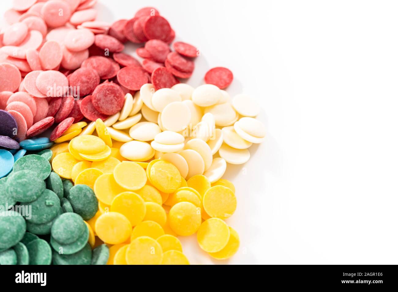 Rainbow colors of round chocolate chips for melting chocolate shapes on ...