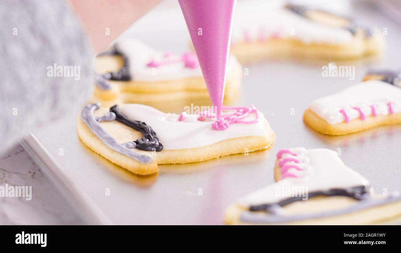 Icing figure skate shaped sugar cookies with royal icing Stock Photo ...