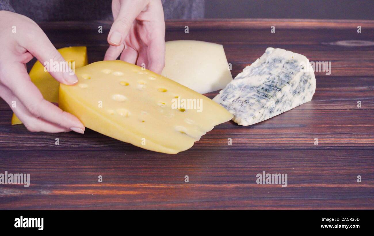 Large wedges of gourmet cheese on a rustic wood background Stock Photo ...