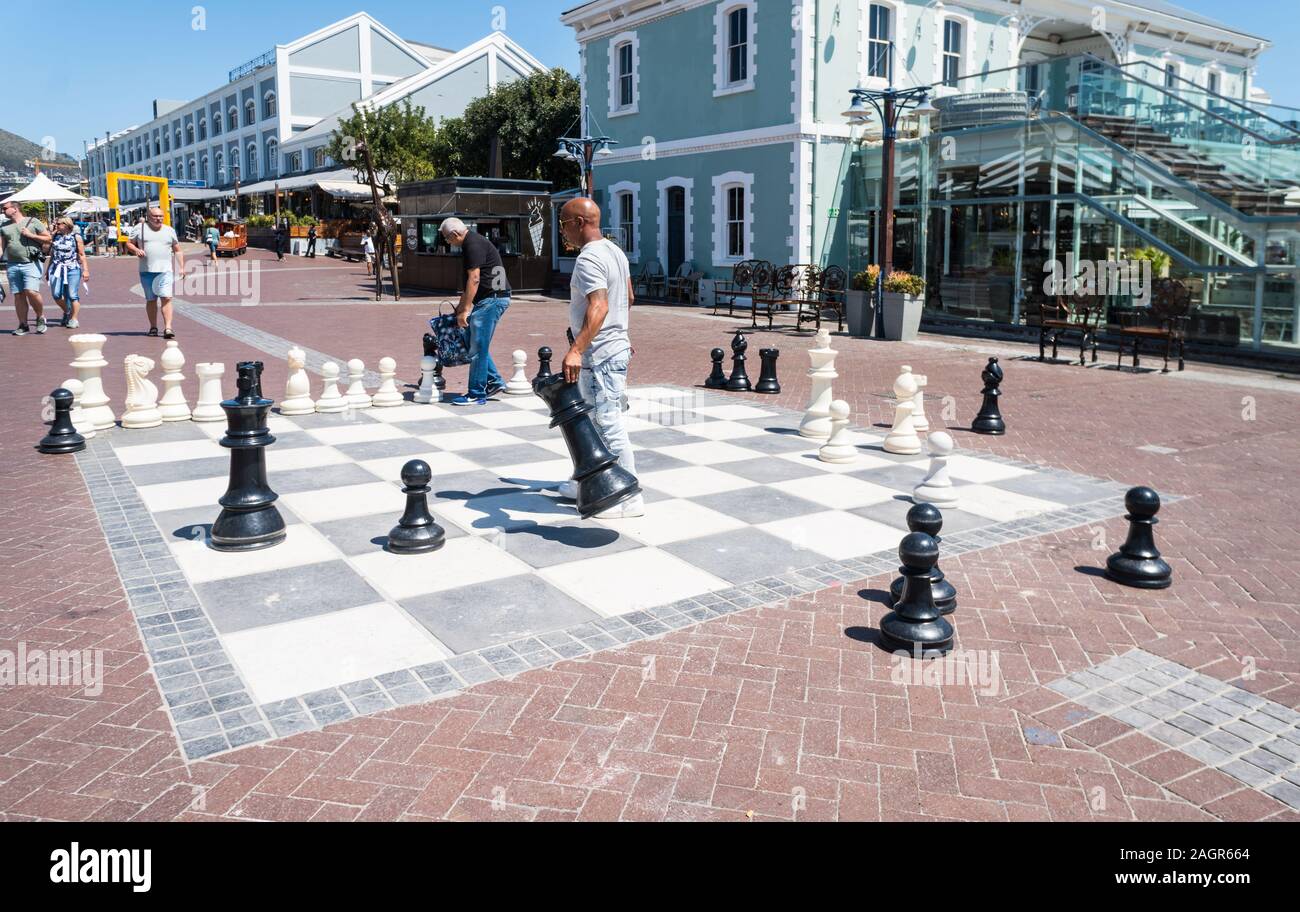 men playing giant chess outdoors in the V&A Waterfront in Cape Town ...