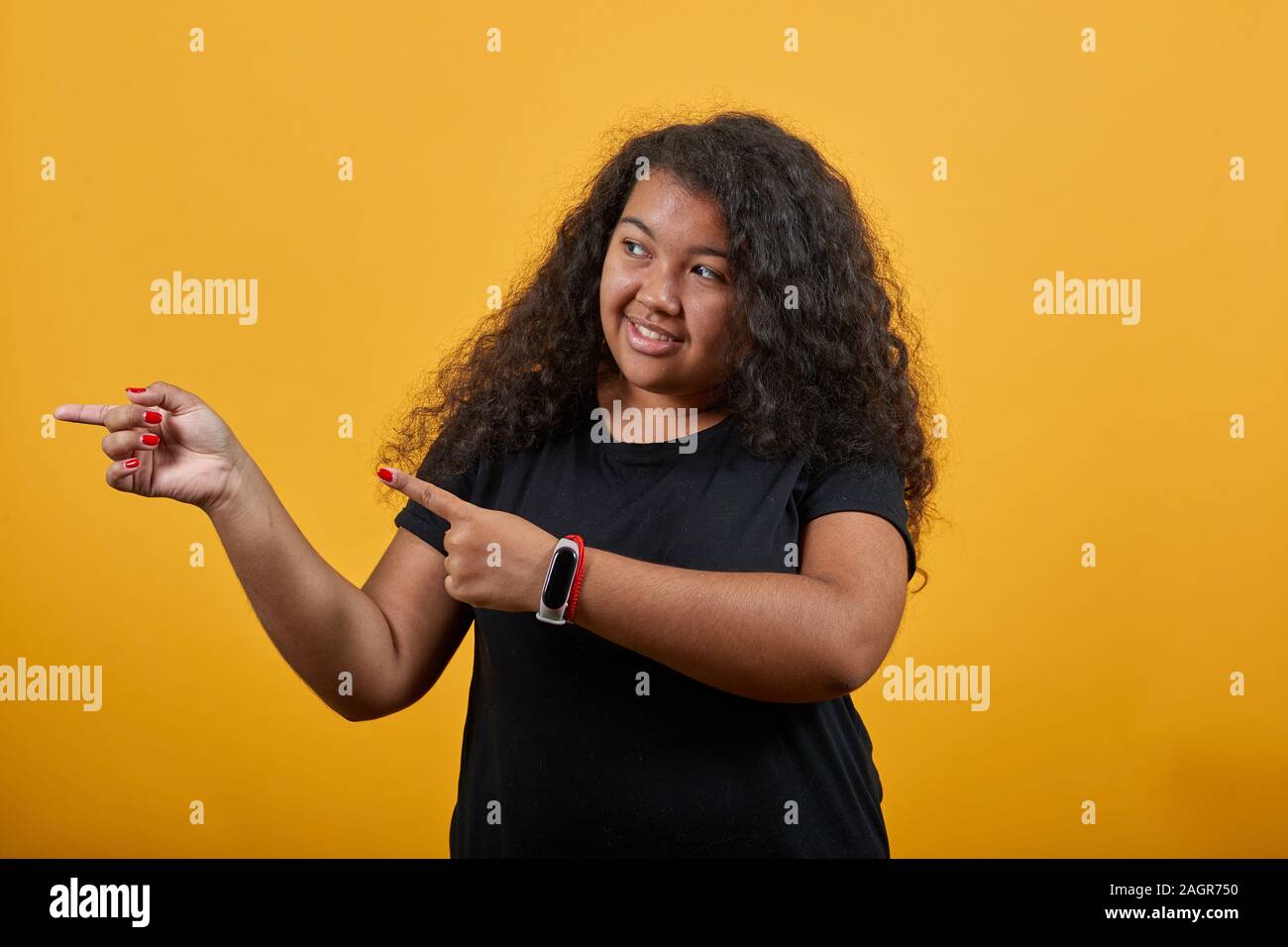 Happy young woman with overweight pointing hands aside, smiling Stock ...