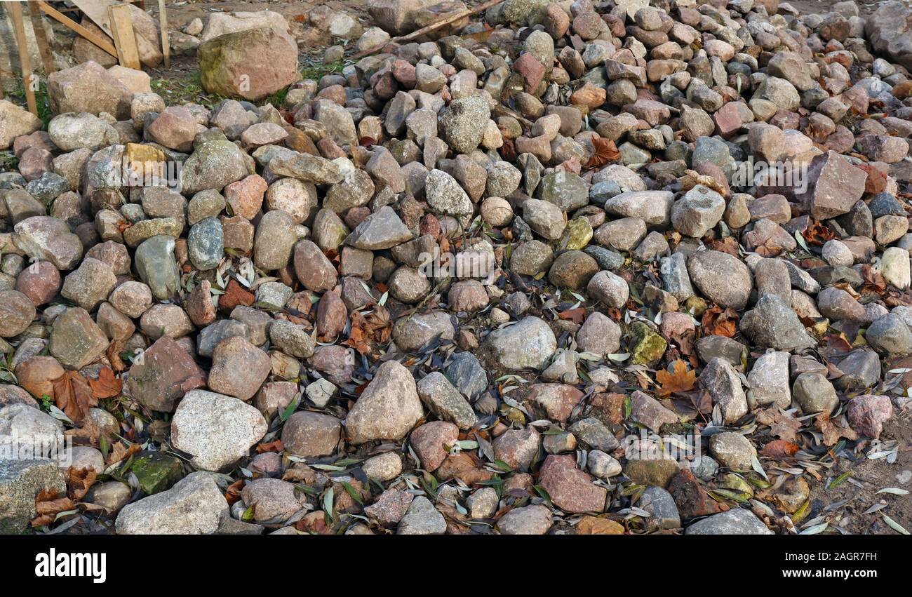 A large pile of small granite cobble stones for the construction of a ...