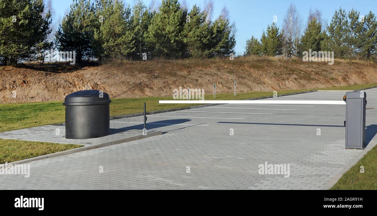 Plastic white barrier and black waste garbage container installed near ...