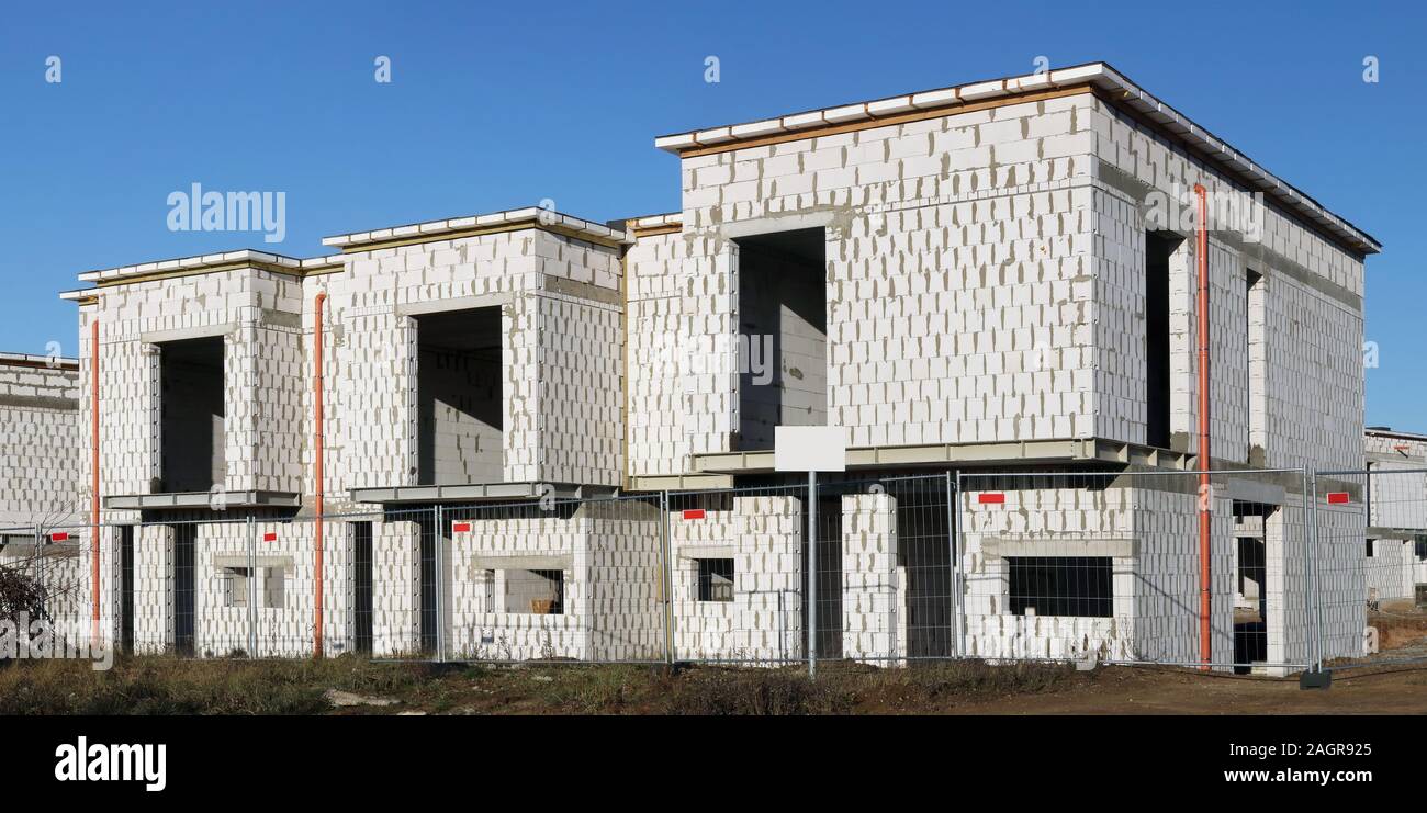 The building of unfinished rural houses from white bricks . Sunny ...