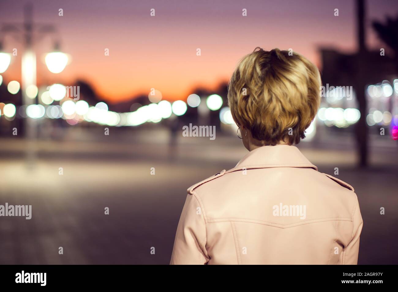 Woman walking on the street in the night time. People and lifestyle ...