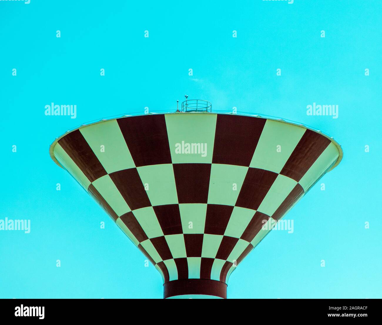 A huge water tower towering into the sky. It's shape and colours ...