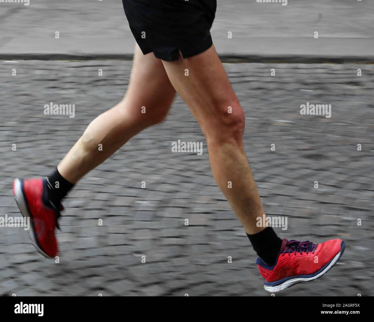 long legs of the fast athlete during a road race Stock Photo - Alamy