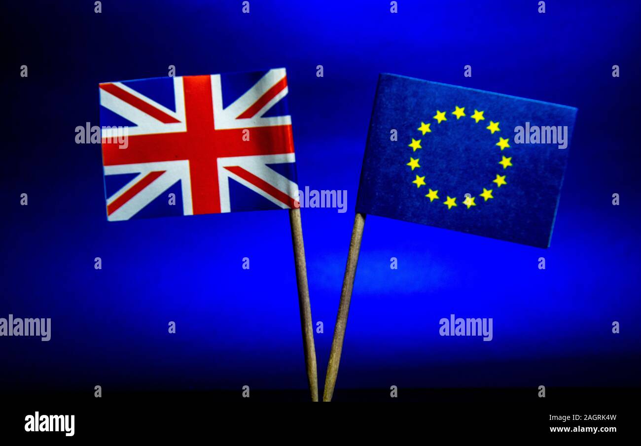 The British and EU flags stand together, against a sky blue background ...