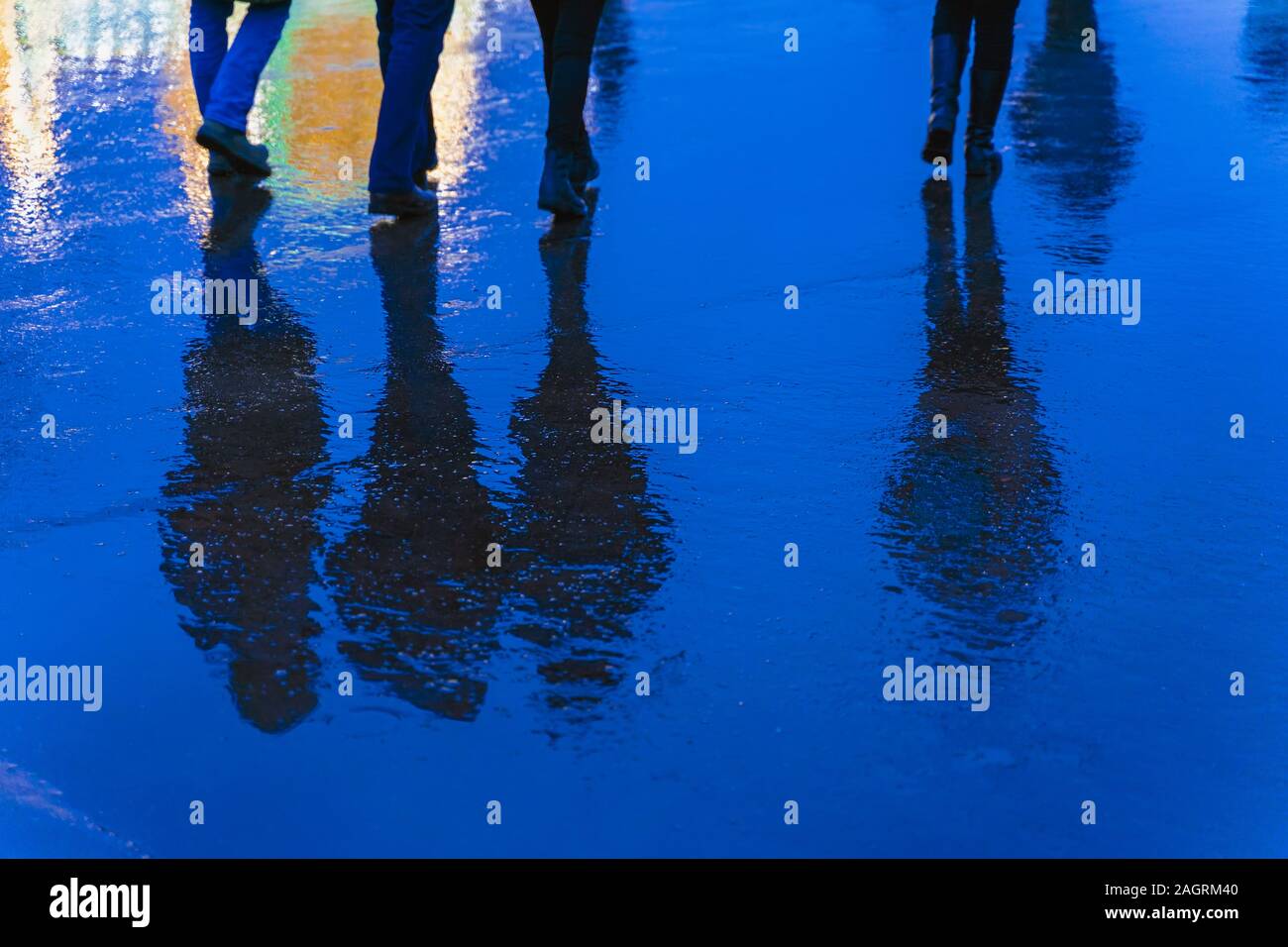 Blurry reflection legs and shadows, silhouettes of the people in the ...